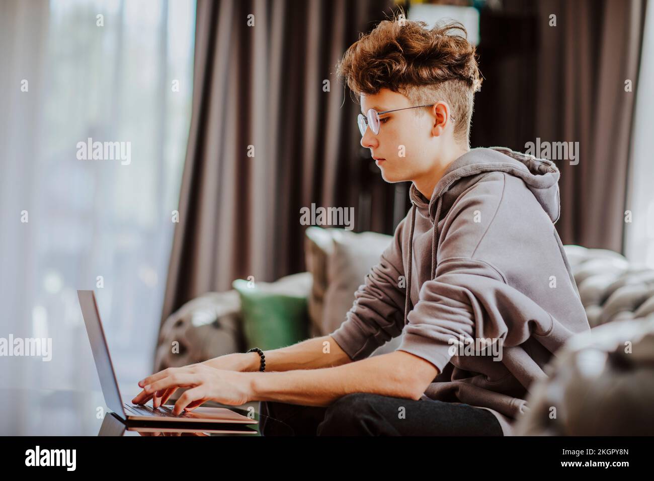 Teenage student studying through laptop at home Stock Photo - Alamy