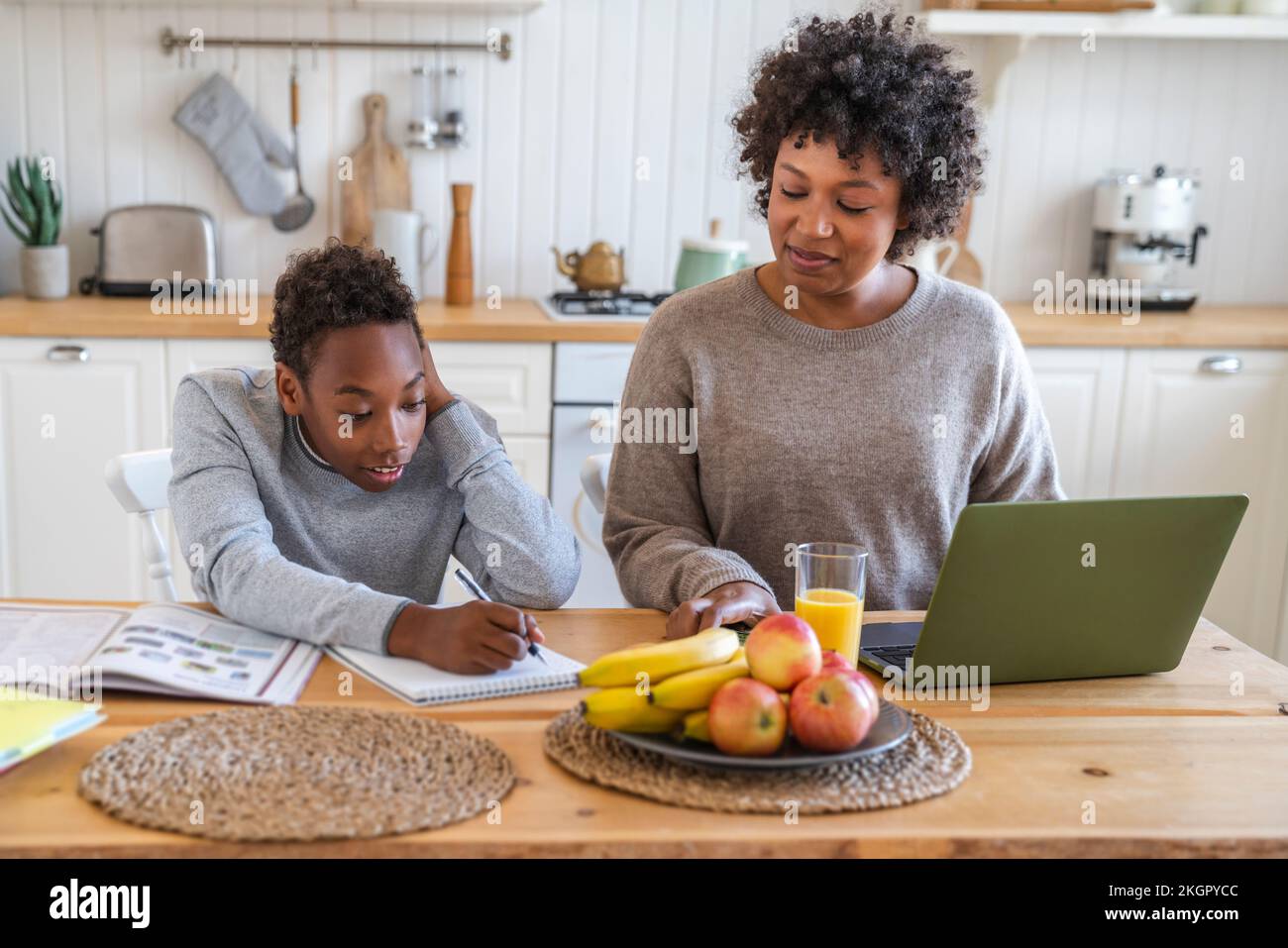 Son helping mother kitchen hi-res stock photography and images - Alamy