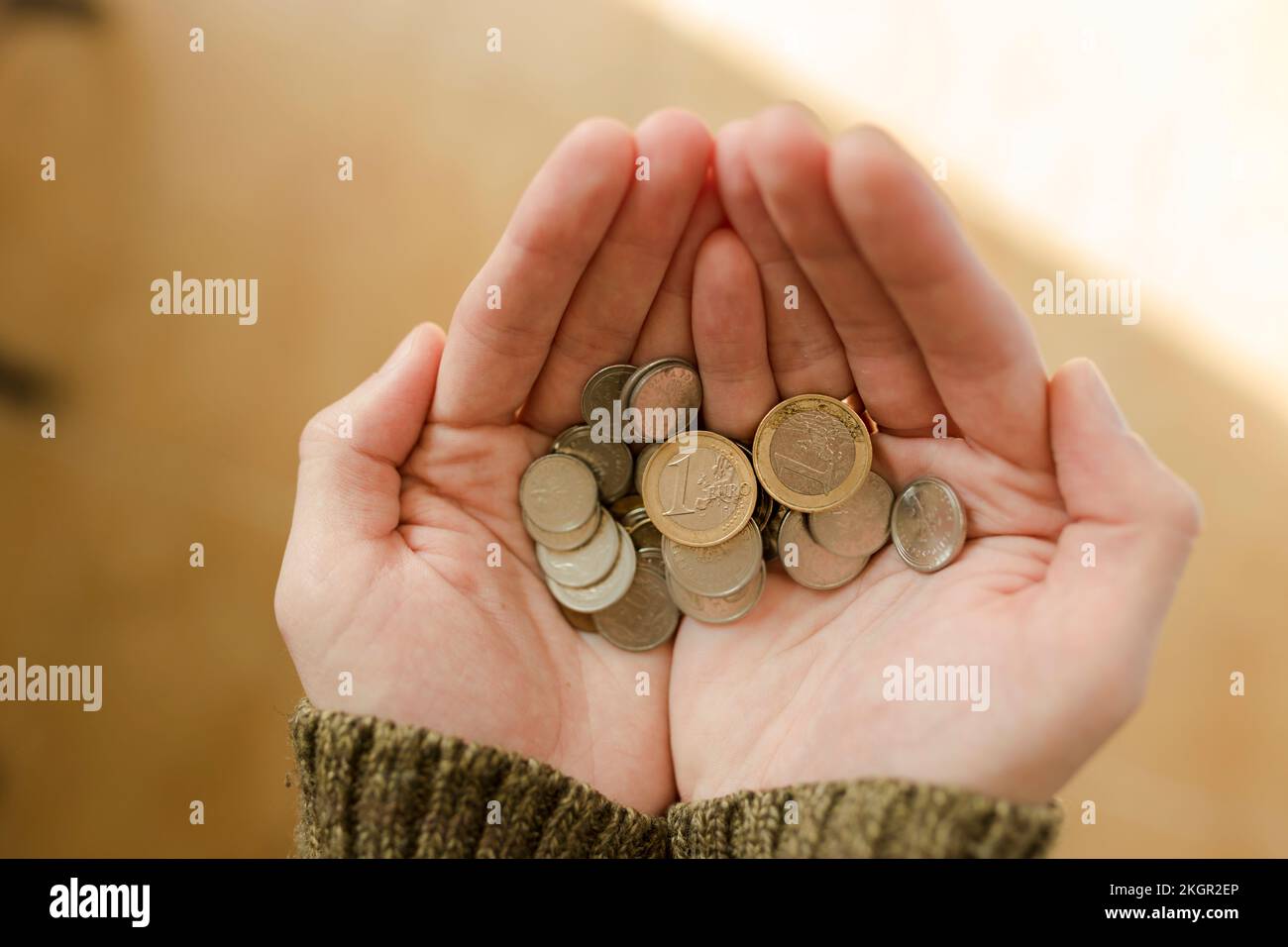 Euro coin on hands hi-res stock photography and images - Alamy