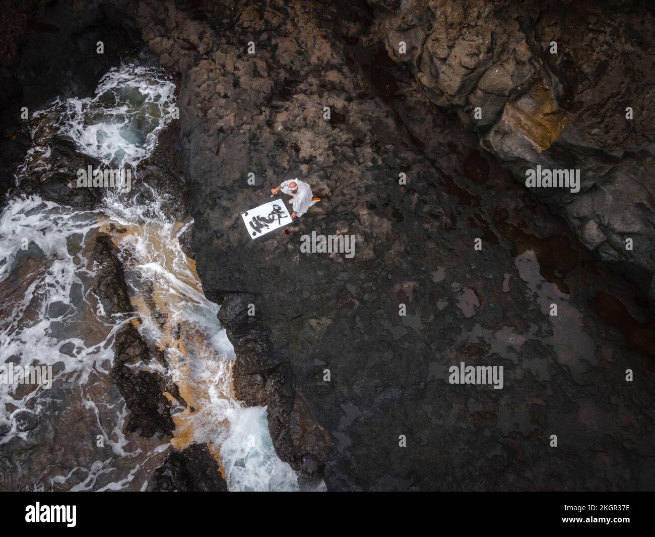 Monk doing calligraphy in front of sea Stock Photo - Alamy