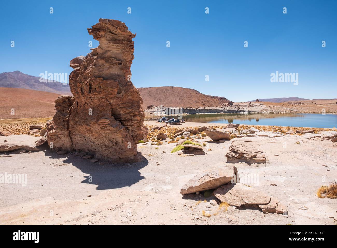 Guided tour vehicles taking a break near the Laguna Negra (Black Lagoon ...