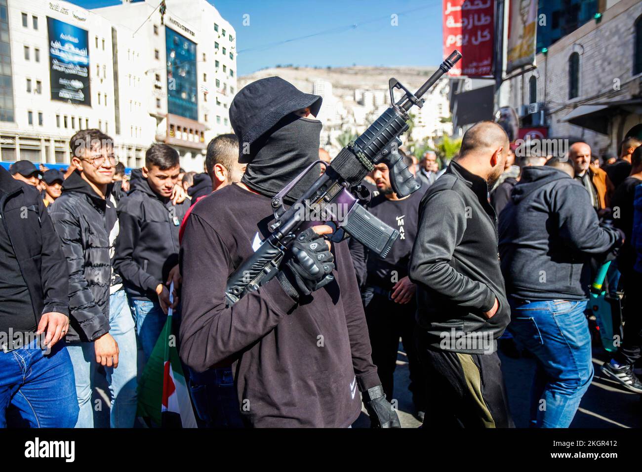 A masked gunman takes part during the funeral of Palestinian Amjad ...