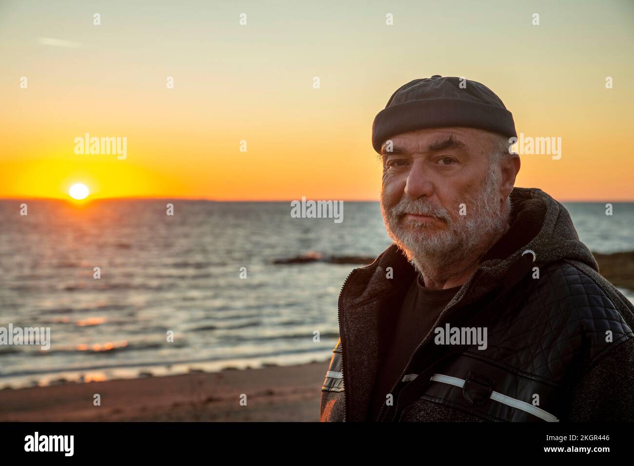 Retired senior man enjoying sunset at beach Stock Photo - Alamy