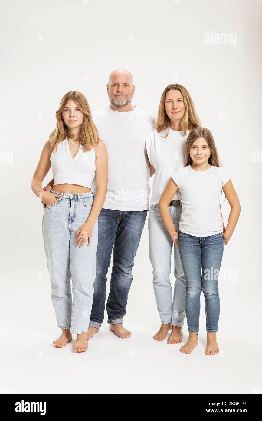 Smiling family standing together against white background Stock Photo ...