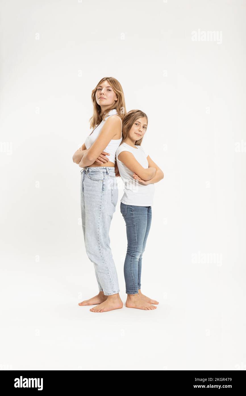 Confident girls with arms crossed in studio Stock Photo - Alamy