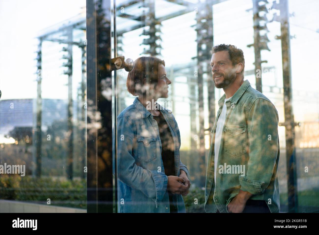Couple standing behind glass wall hi-res stock photography and images ...
