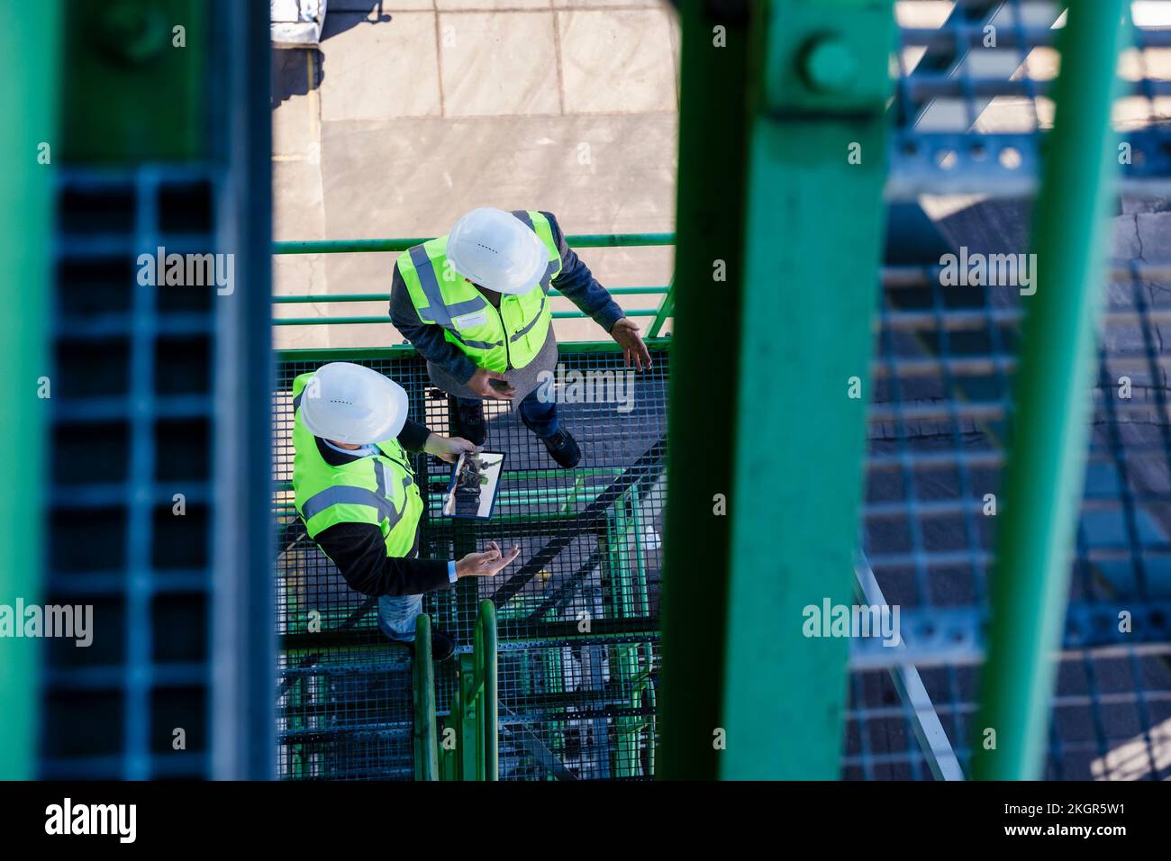 Engineers examining and having discussion at industrial plant Stock ...