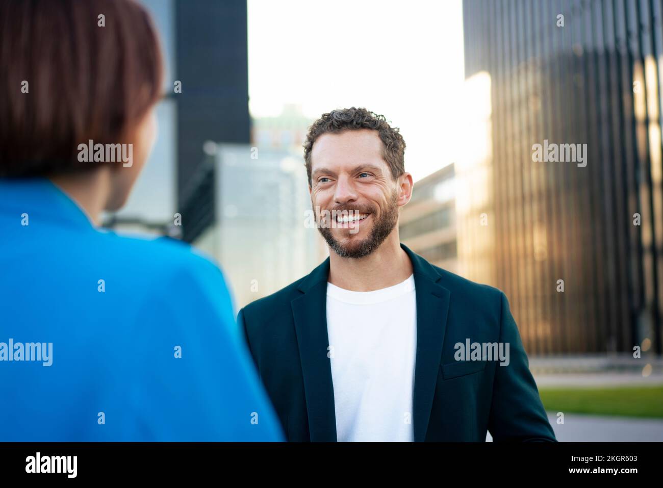 Happy businessman discussing with colleague Stock Photo - Alamy