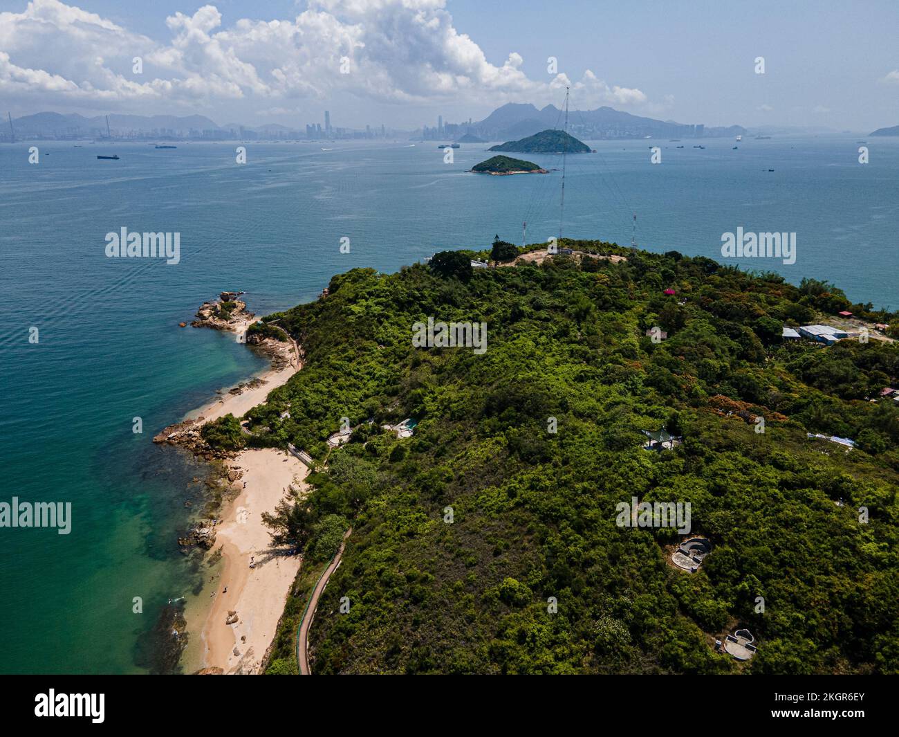 A bird's eye view of Peng Chau beach surrounded by green forested hills in Hong Kong Stock Photo ...