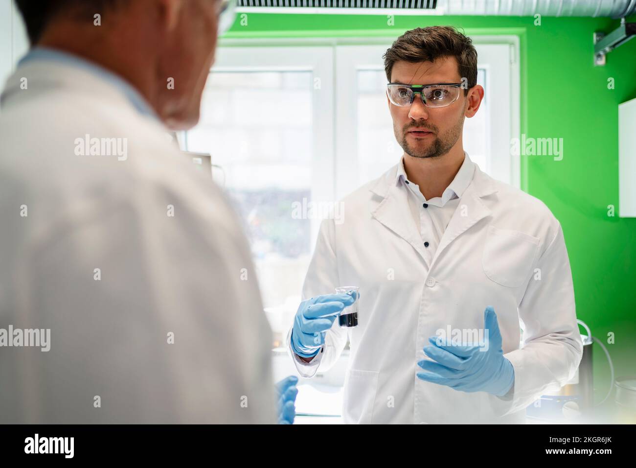 Standing expertise discussion holding technology laboratory hi-res ...