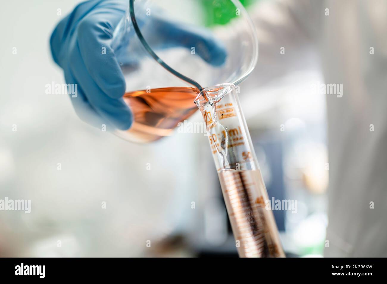 Hand of scientist pouring chemical in test tube at laboratory Stock ...