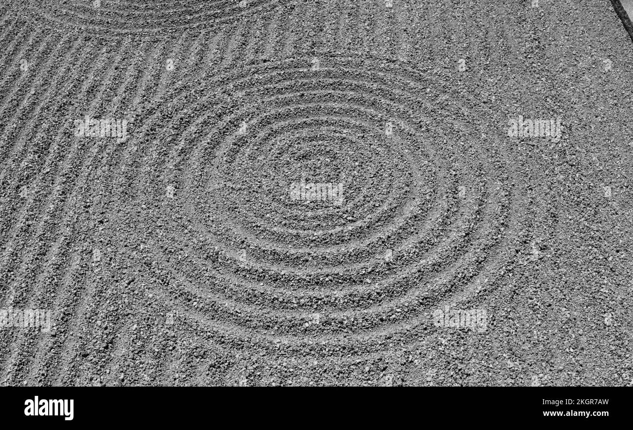 A grayscale shot of circle shape rock design in a rock garden in Kyoto ...