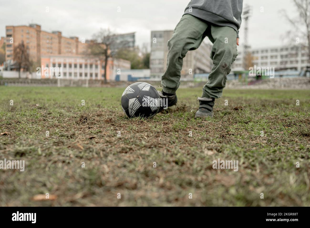 Child kicking ball hi-res stock photography and images - Alamy
