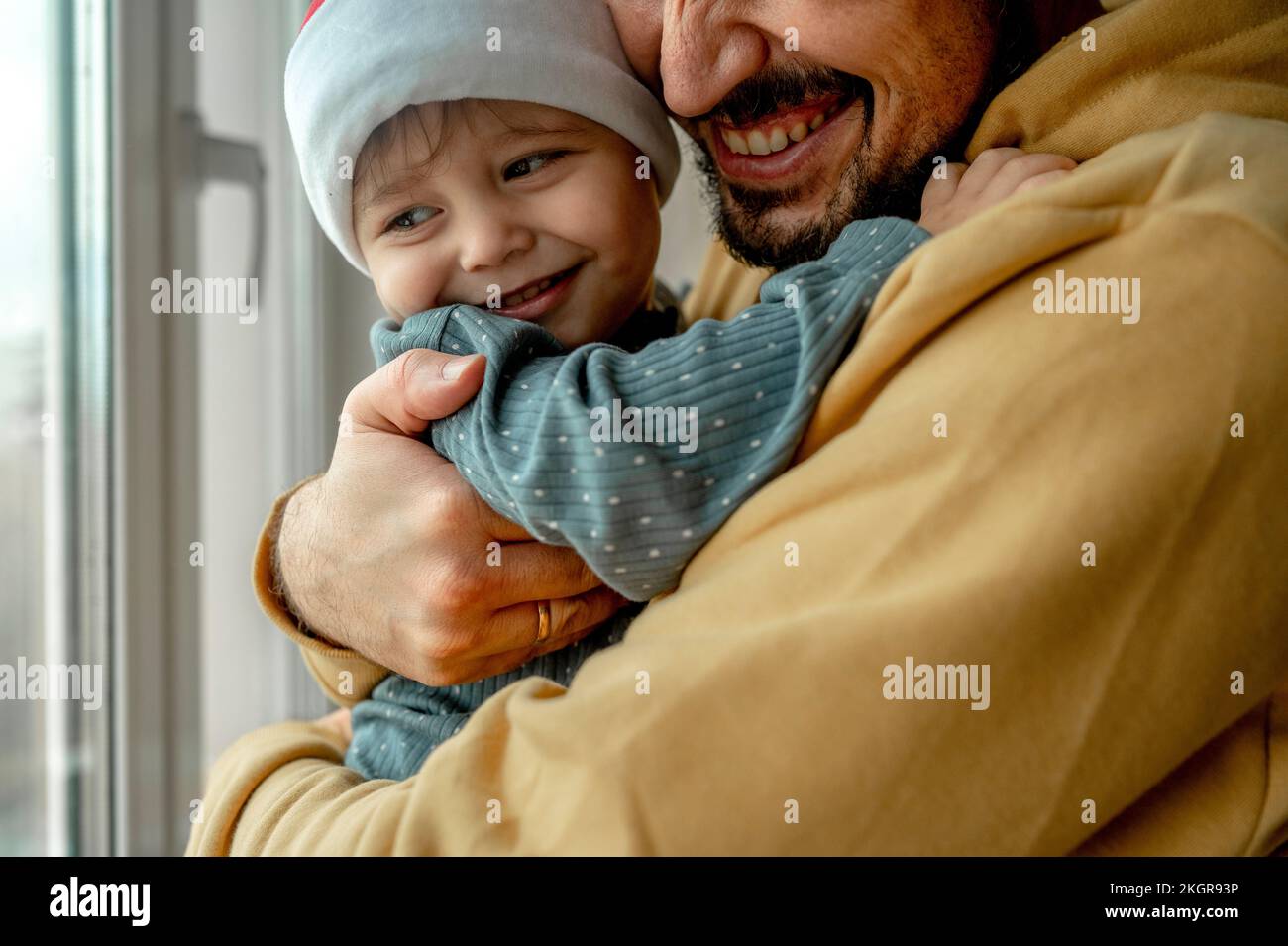 Cute boy hugging father at home Stock Photo - Alamy