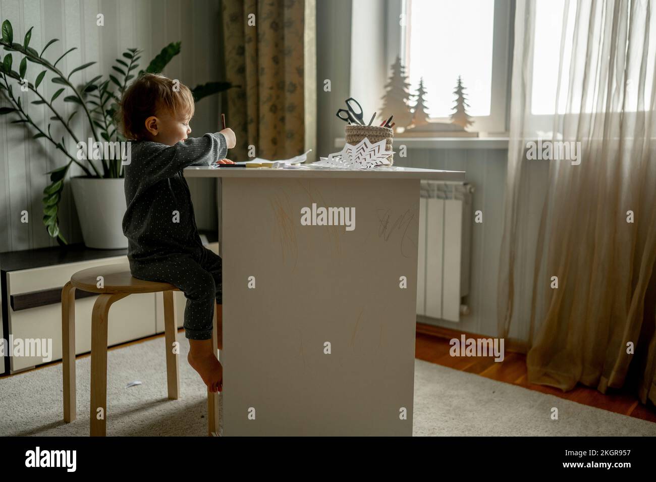Toddler doing drawing at table Stock Photo - Alamy