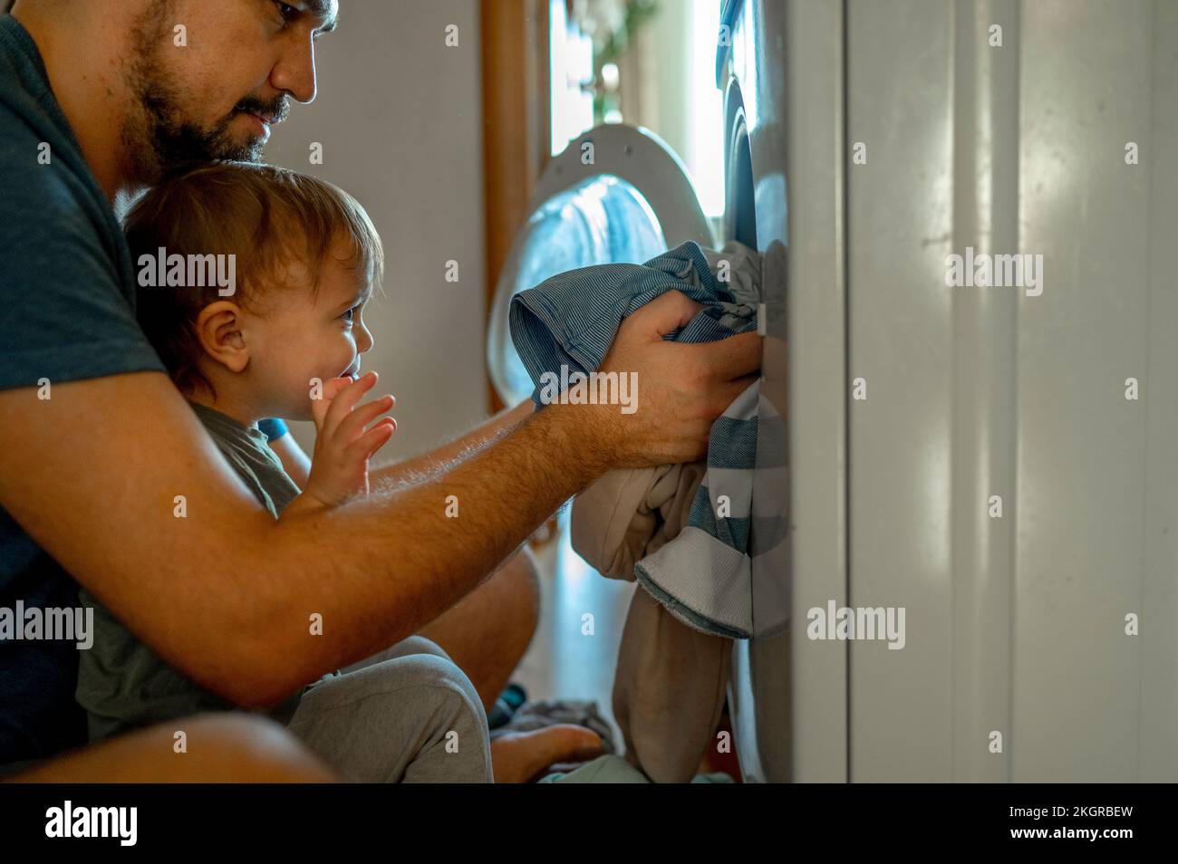 Father with son doing household chores at home Stock Photo - Alamy
