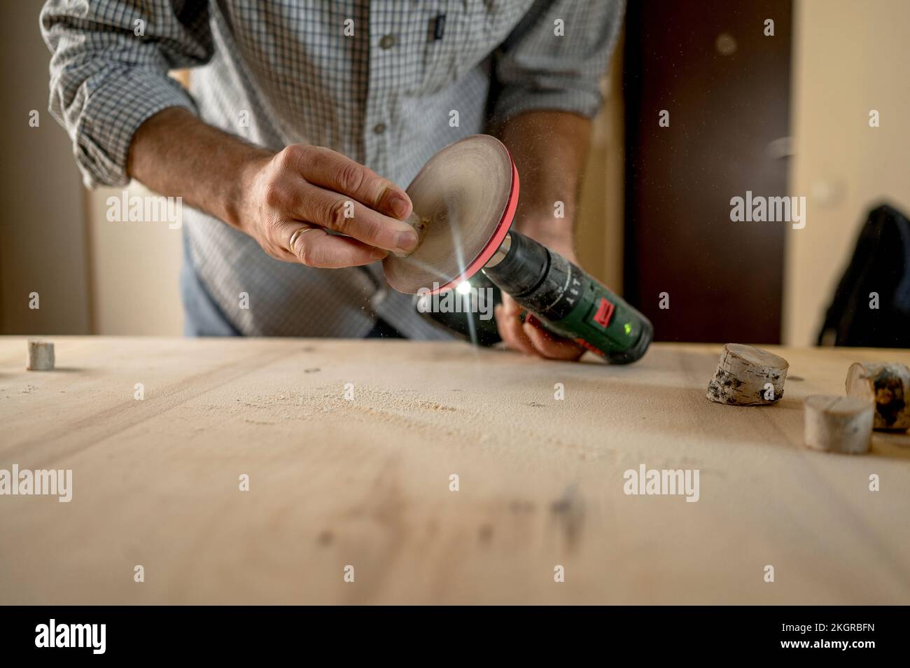 Craftsman shaping wood through grinder making toys at home Stock Photo ...