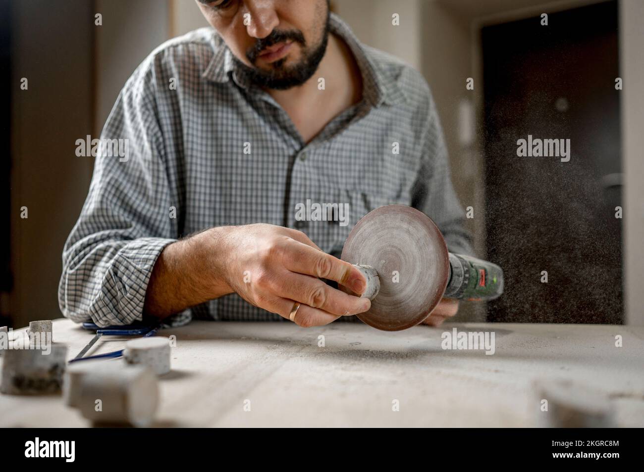 Craftsman shaping wood holding grinder Stock Photo - Alamy