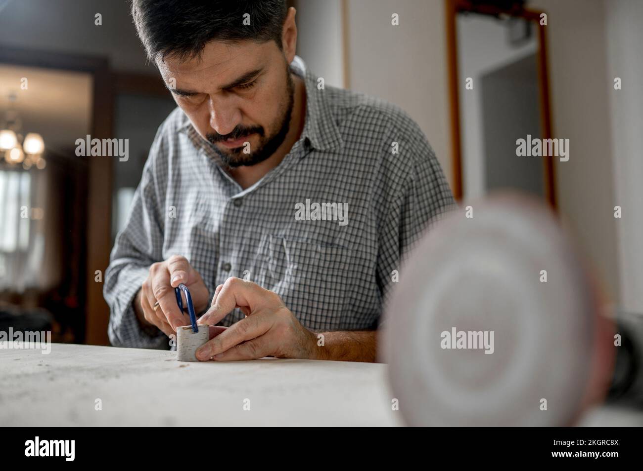 Craftsman cutting wood using hexablade at home Stock Photo - Alamy