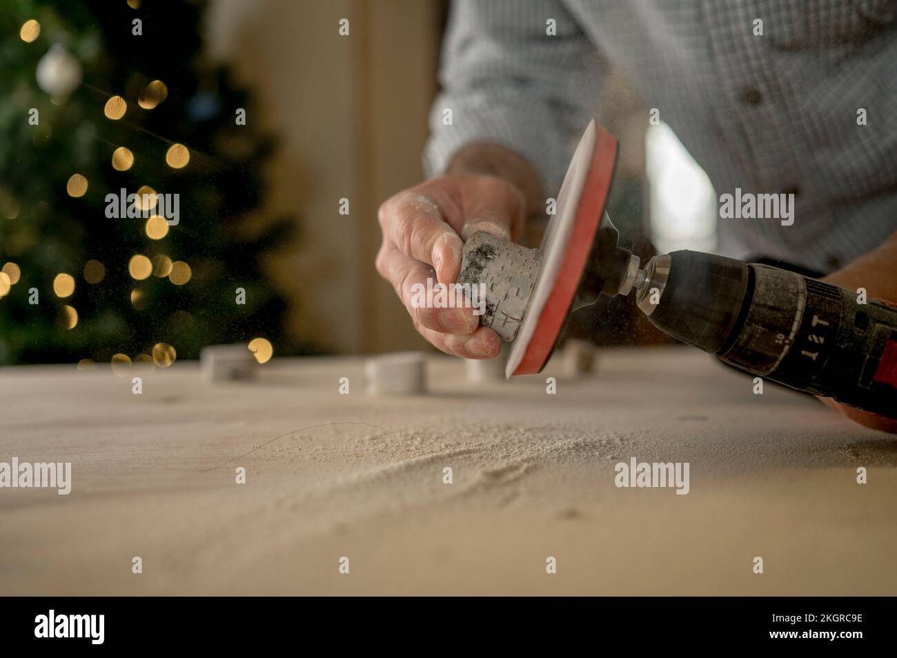 Craftsman shaping wood through grinder Stock Photo - Alamy