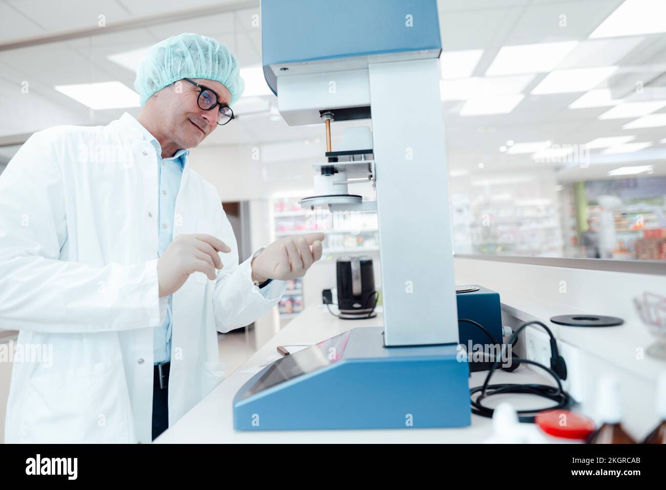 Smiling chemist wearing eyeglasses experimenting in laboratory Stock ...
