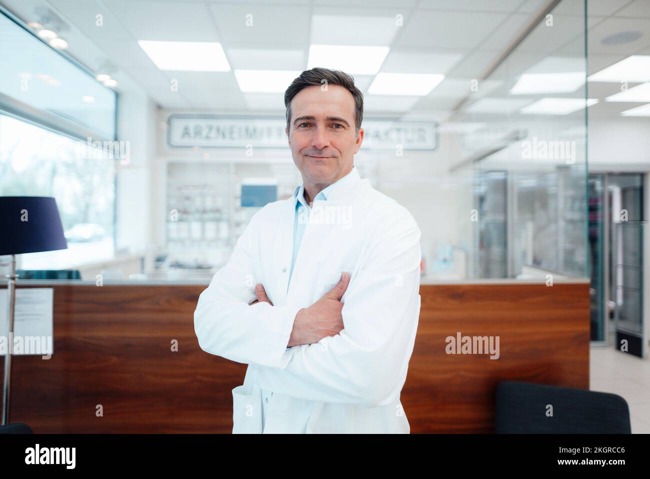 Smiling doctor looking camera arms hi-res stock photography and images ...