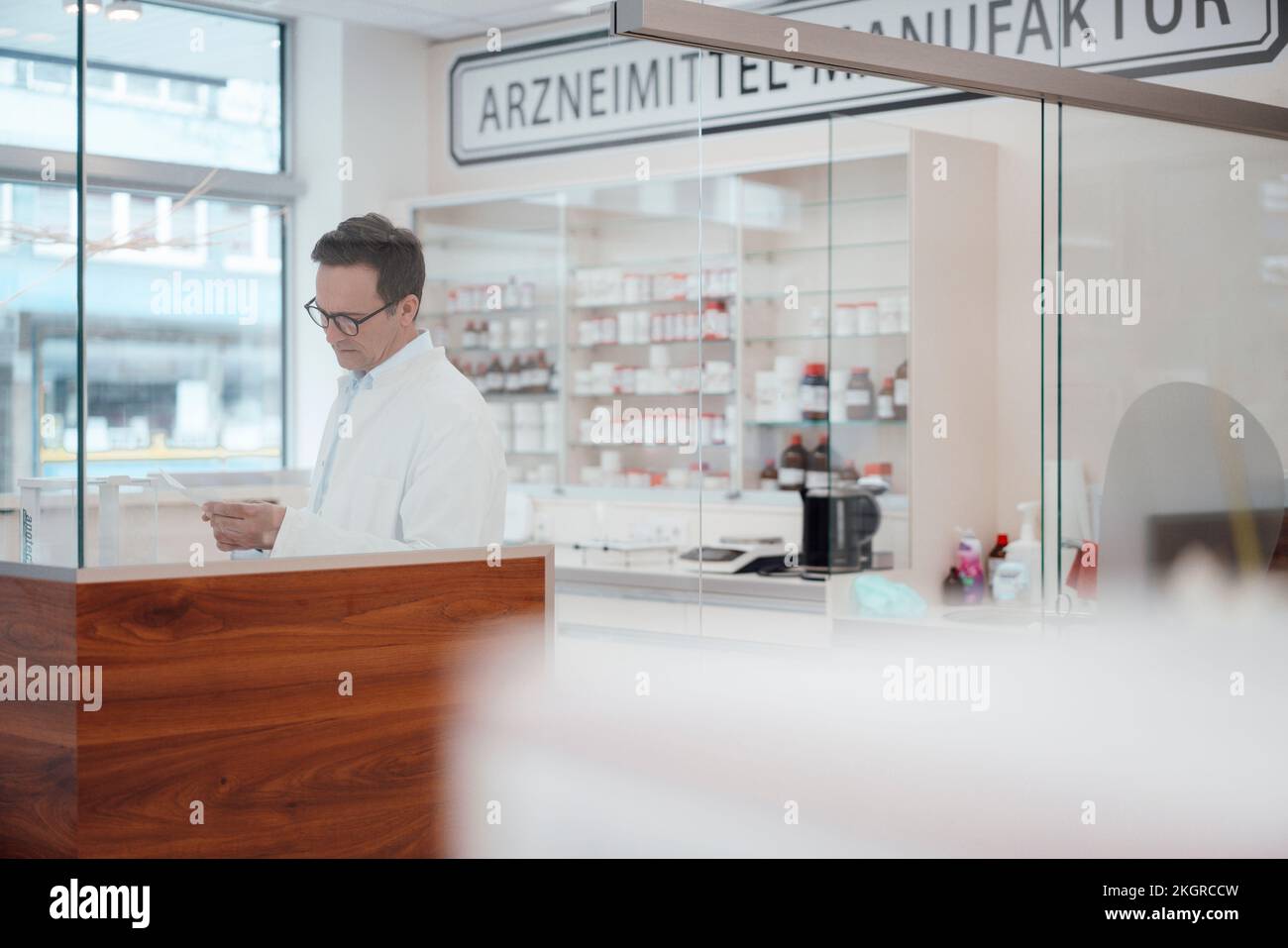 Pharmacist examining checklist at store Stock Photo - Alamy