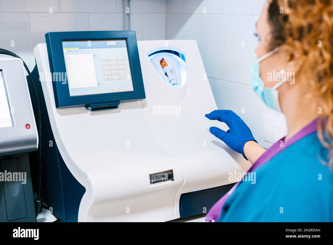 Woman analyzing blood sample on hi-res stock photography and images - Alamy