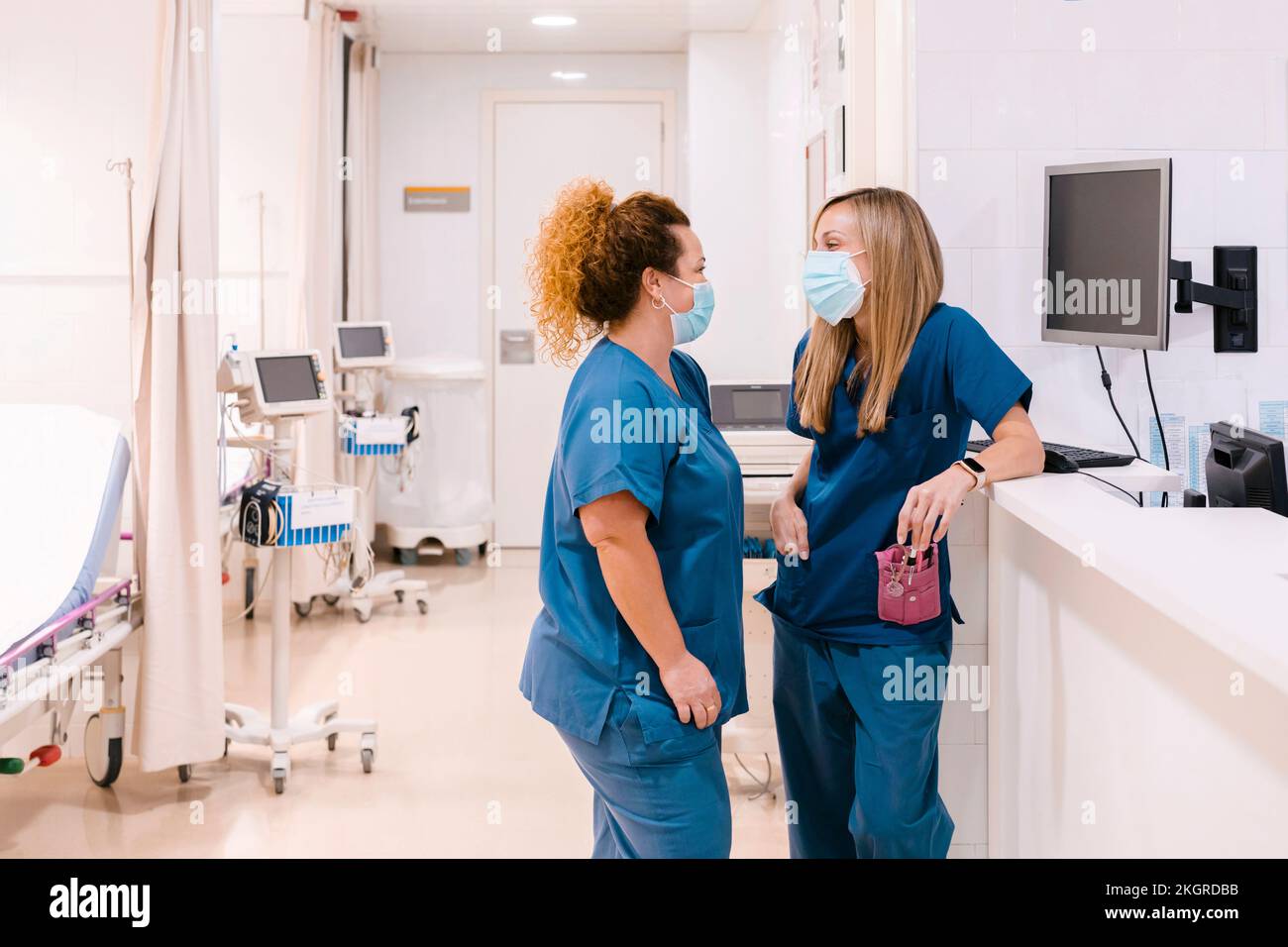 Mature nurse talking to colleague at hospital Stock Photo - Alamy