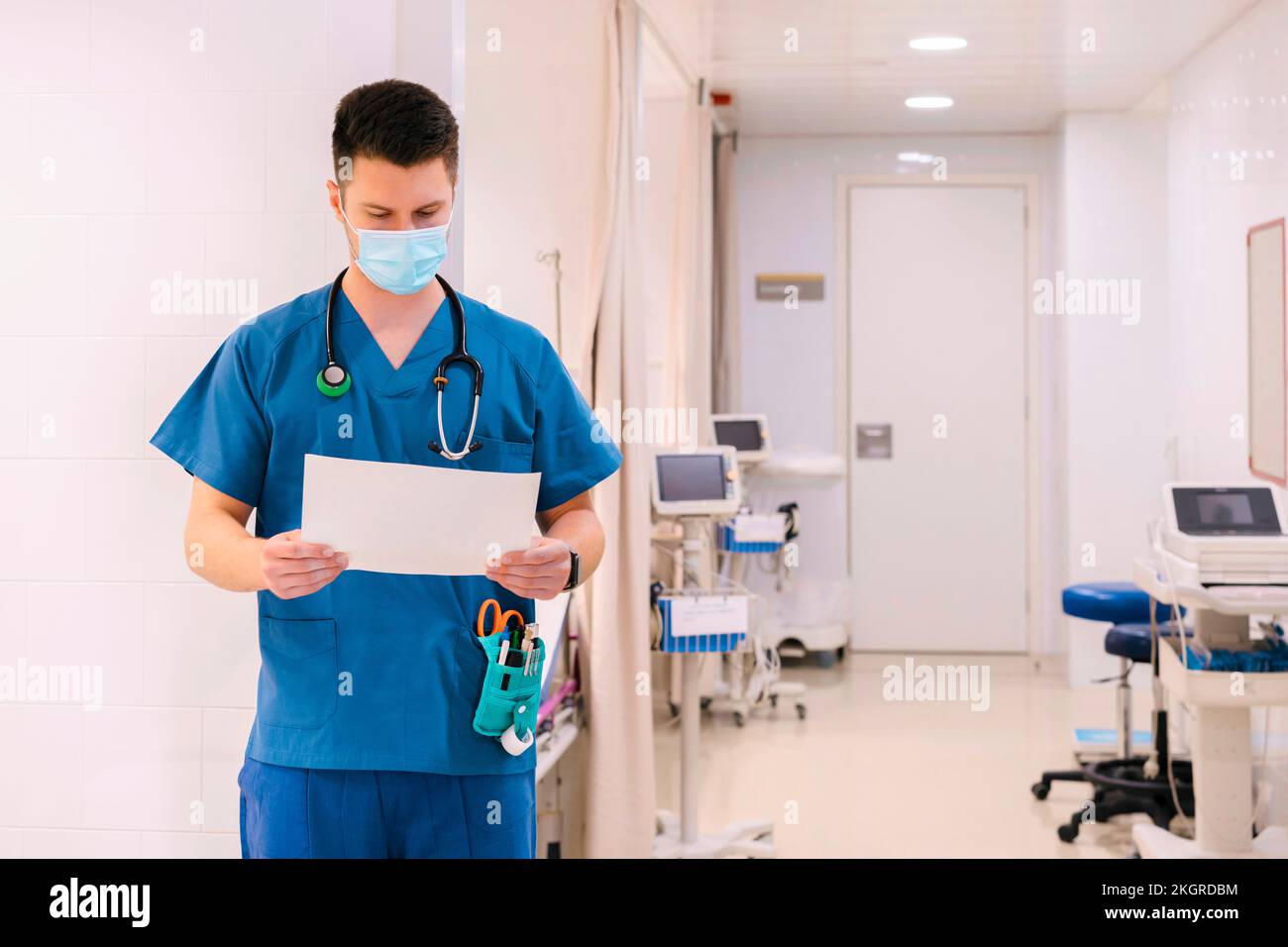 Doctor examining medical test report at hospital Stock Photo - Alamy