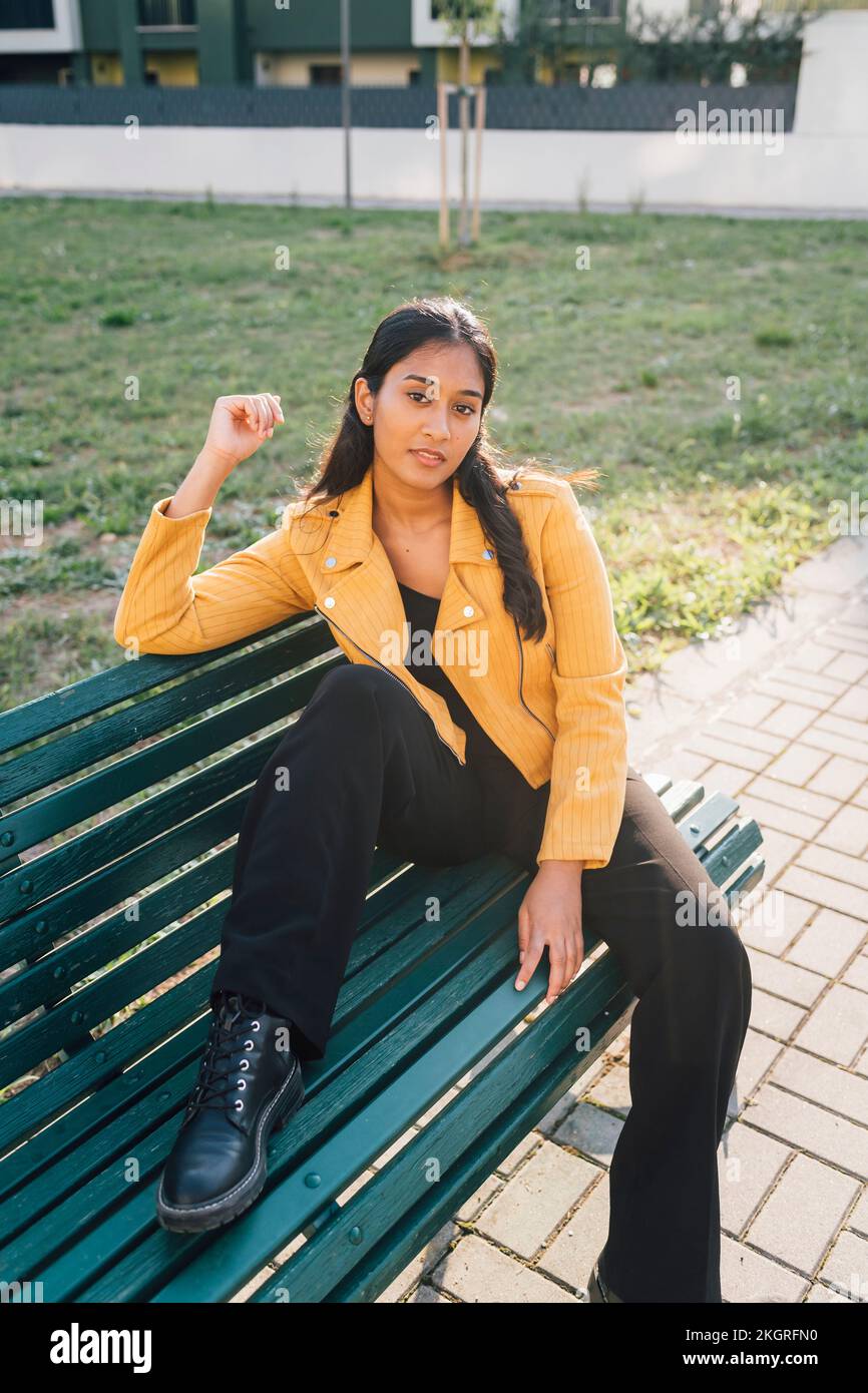 Young woman sitting park bench hi-res stock photography and images - Alamy