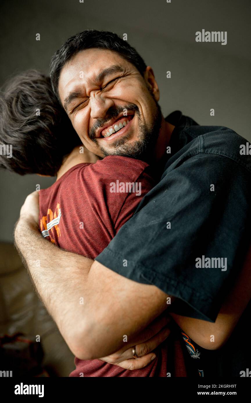 Black man embracing cheerful child hi-res stock photography and images ...