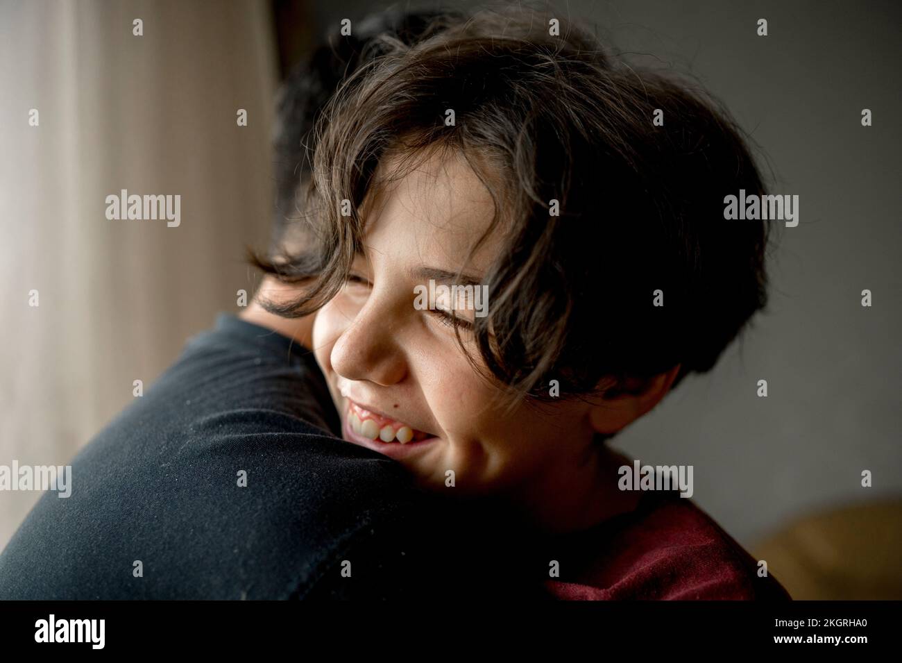 Happy boy hugging father at home Stock Photo - Alamy