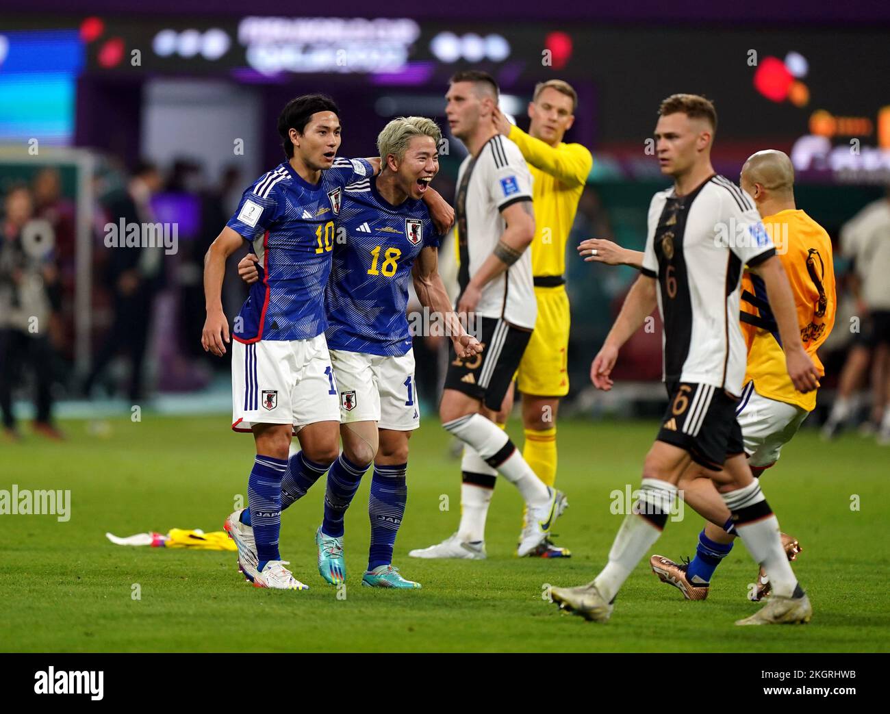 Japan players Takumi Minamino and Takuma Asano celebrate victory over ...