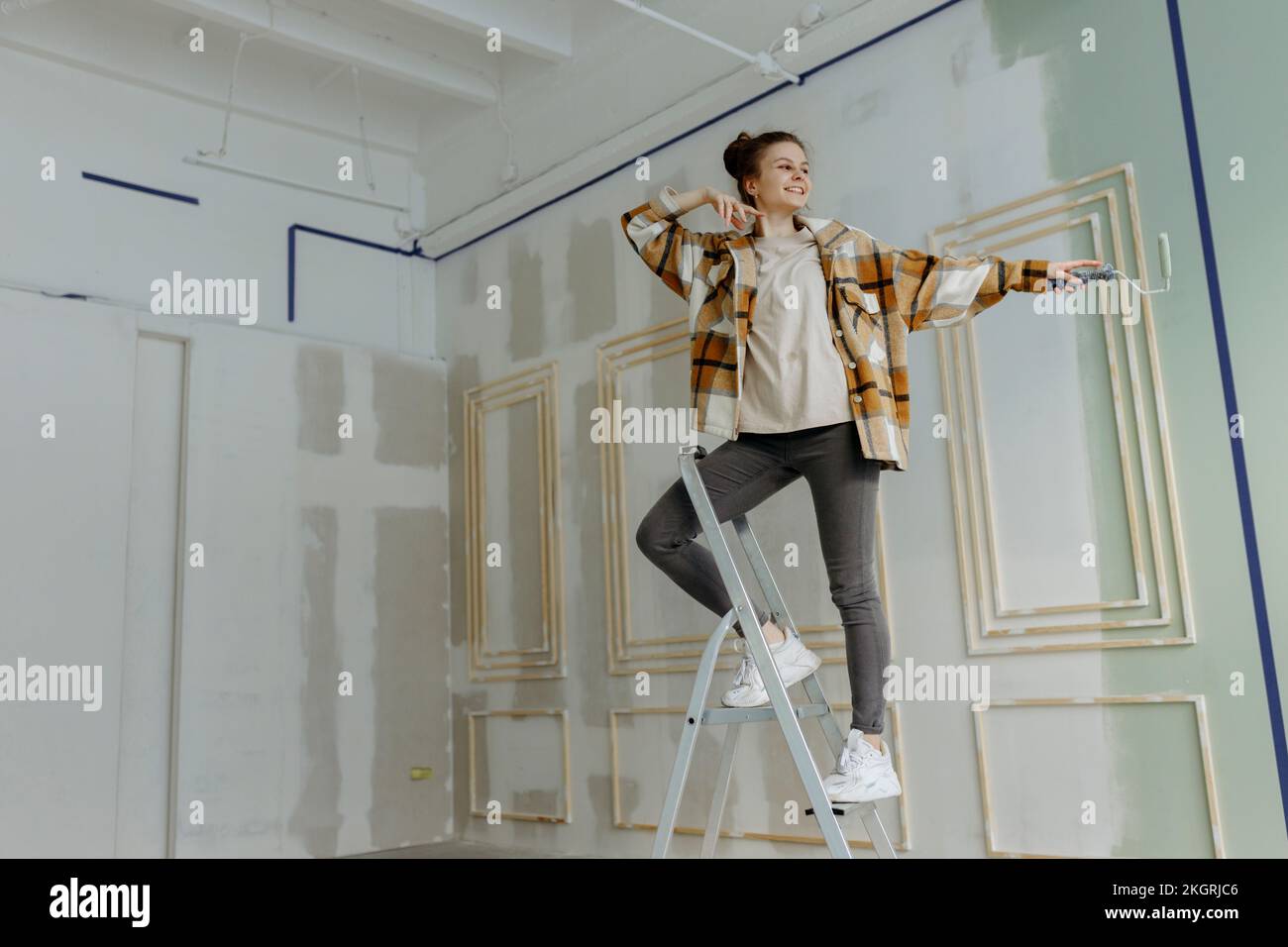 Woman standing on step ladder hi-res stock photography and images - Alamy