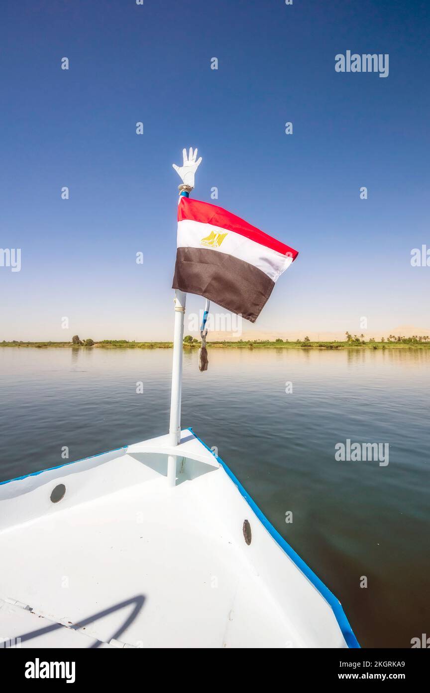 Egypt, Luxor Governorate, Luxor, Egyptian flag on bow of boat floating ...