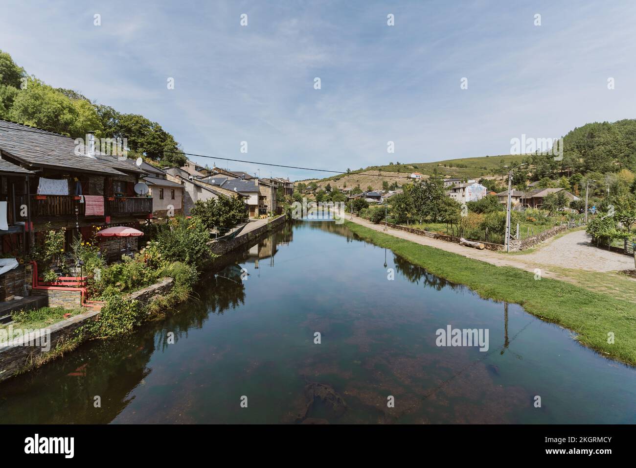 A high-angle of Aldeia de Rio de Onor with a lake view cloudy sunlit ...