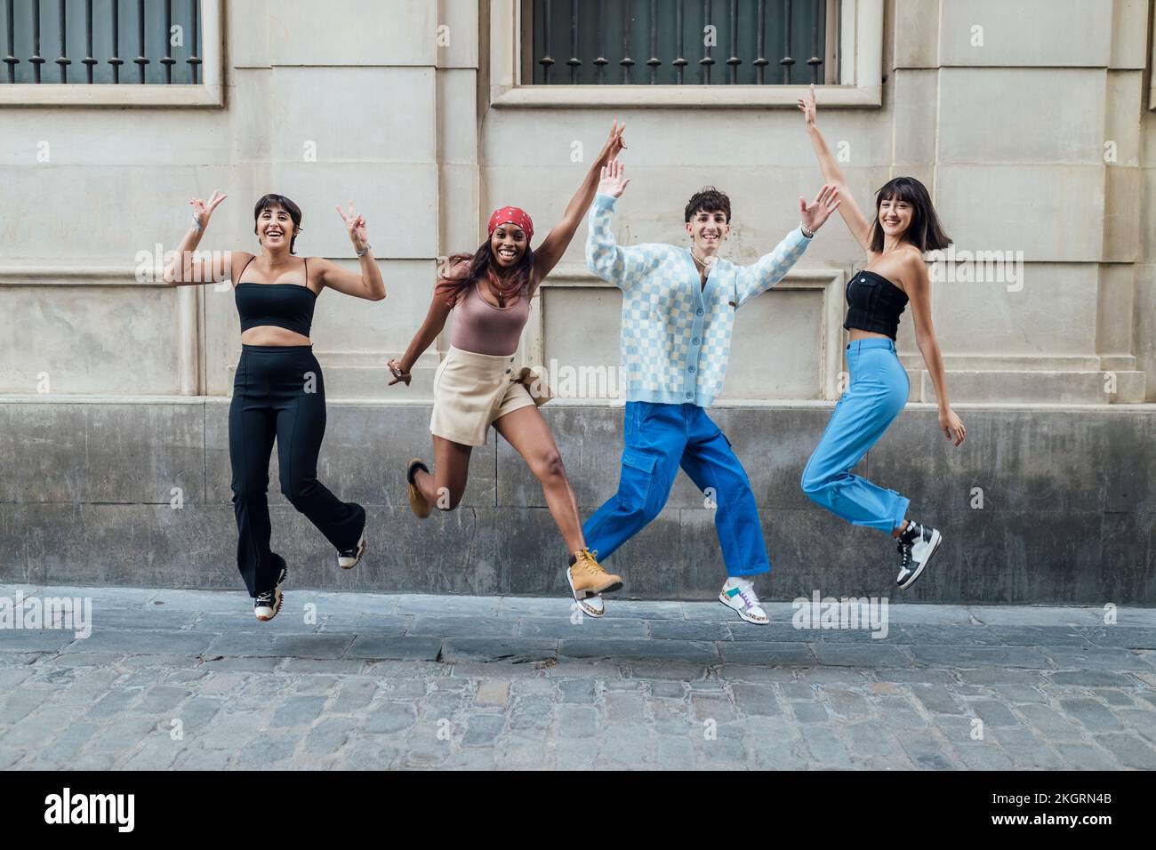 Happy group friends jumping full hi-res stock photography and images ...