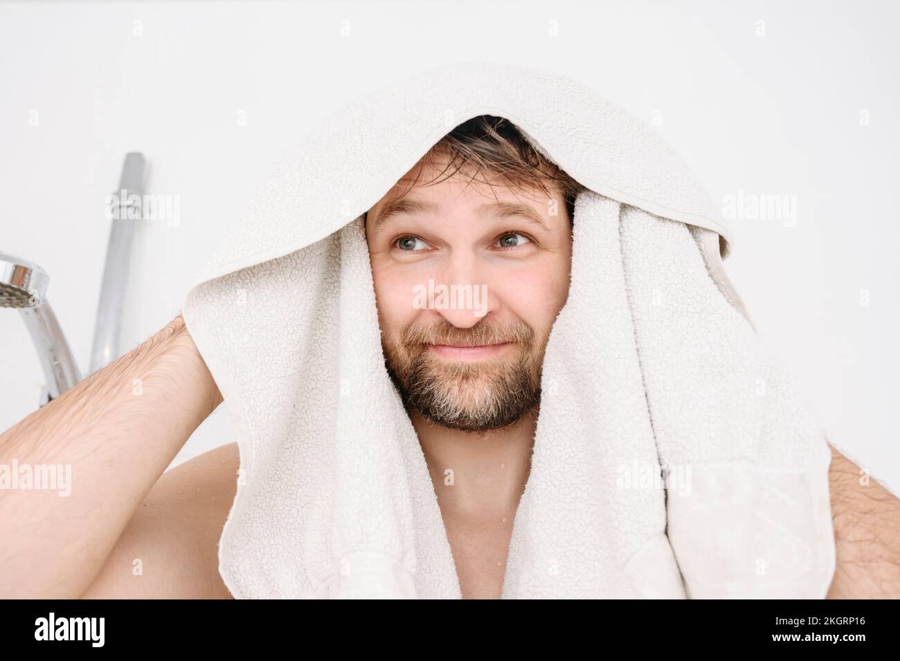 Smiling man drying hair with towel in bathroom at home Stock Photo - Alamy