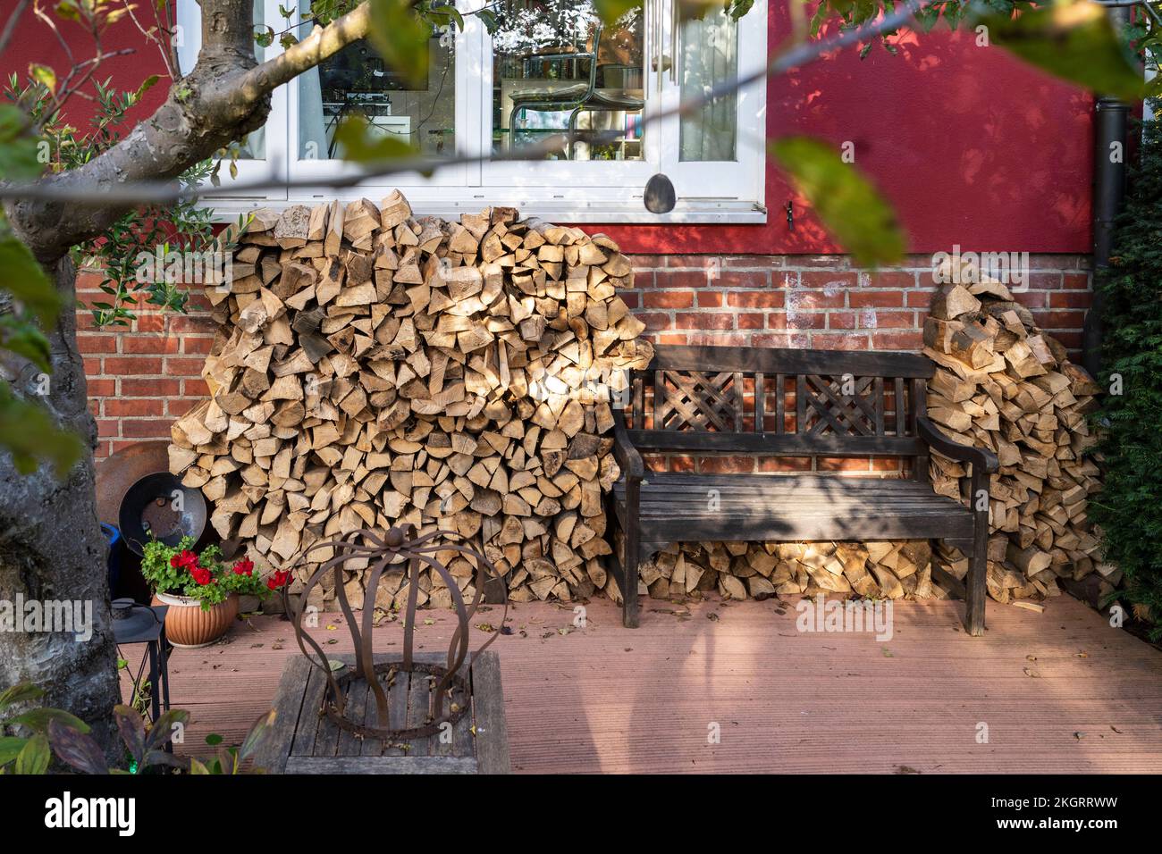Stack of firewood stored in back yard Stock Photo - Alamy