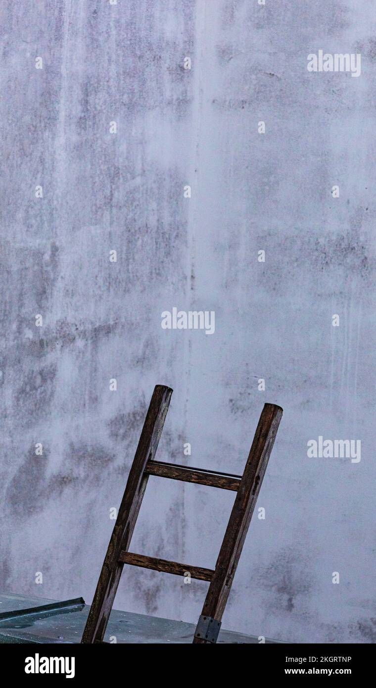 Wooden ladder leaning in front of wall Stock Photo - Alamy