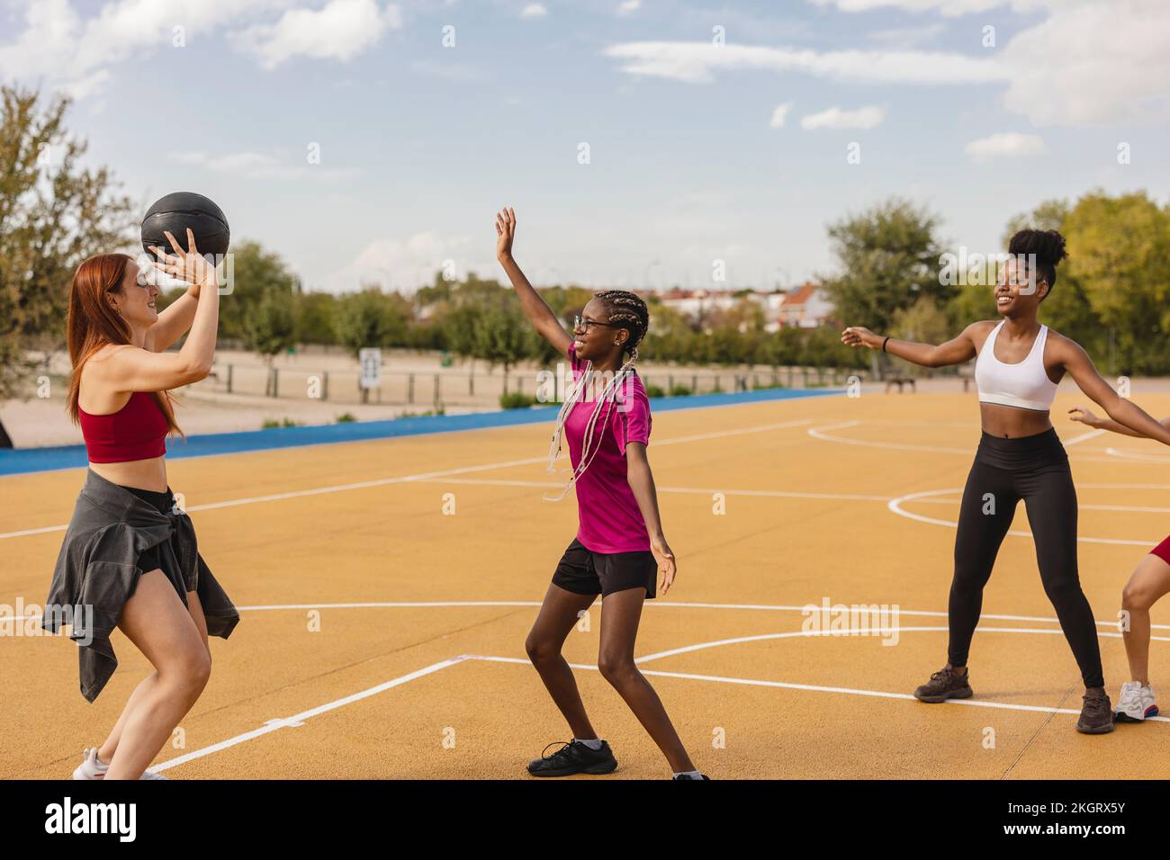 Multi ethnic friends playing basketball hi-res stock photography and ...