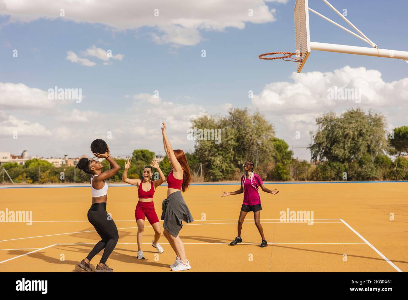Friends having fun playing basketball in sports court Stock Photo - Alamy