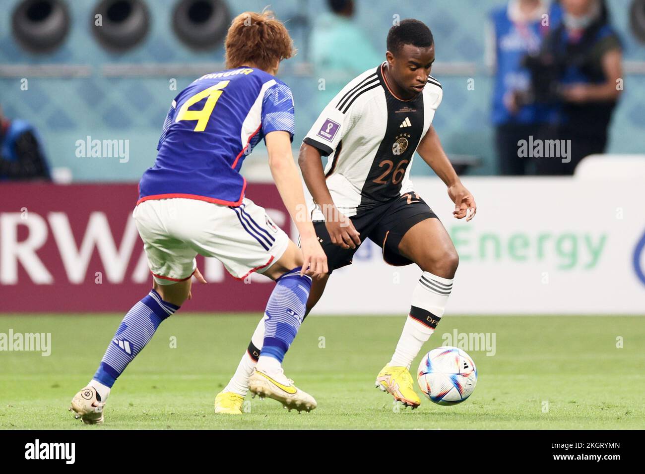 Doha, Qatar. 23rd Nov, 2022. Youssoufa Moukoko (R) of Germany controls ...