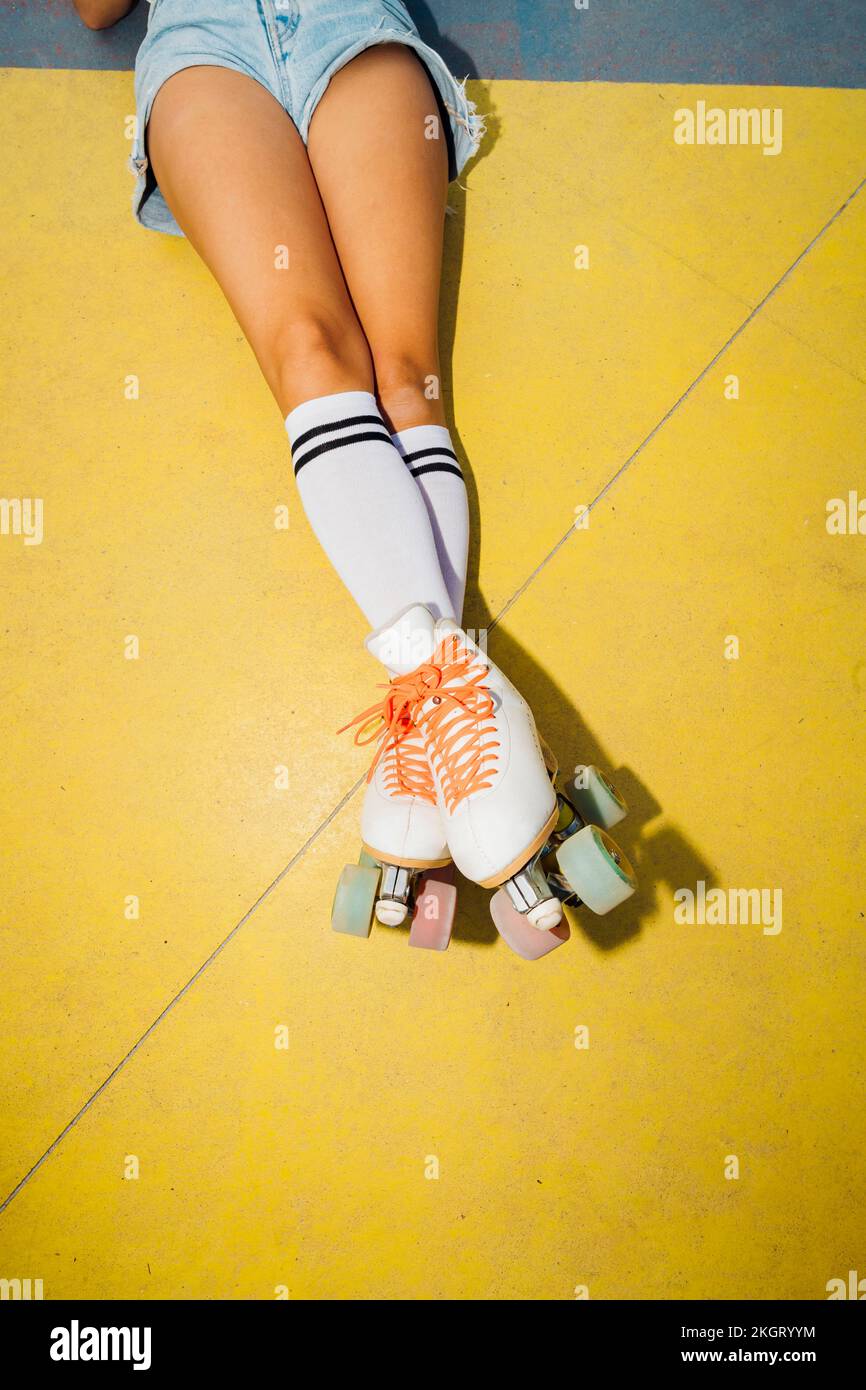 Legs of woman wearing roller skates lying on sports court Stock Photo ...