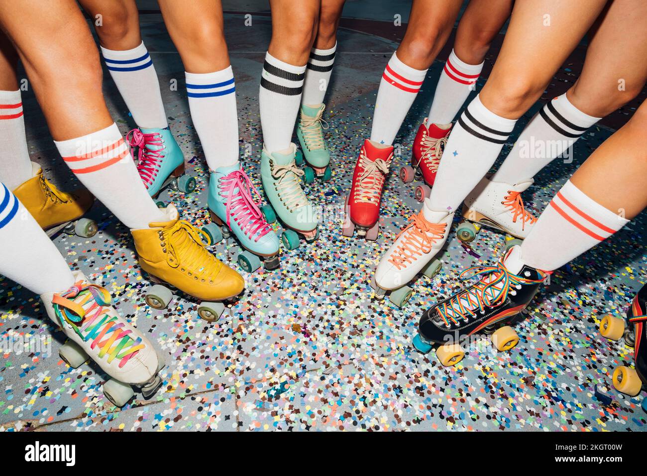 Legs of women wearing roller skates over confetti Stock Photo - Alamy