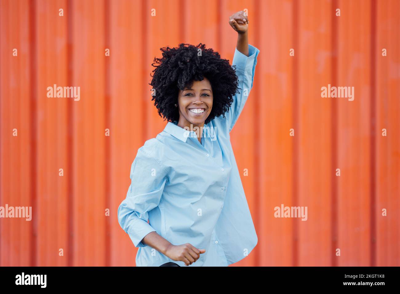Young woman dancing outdoors orange hi-res stock photography and images ...