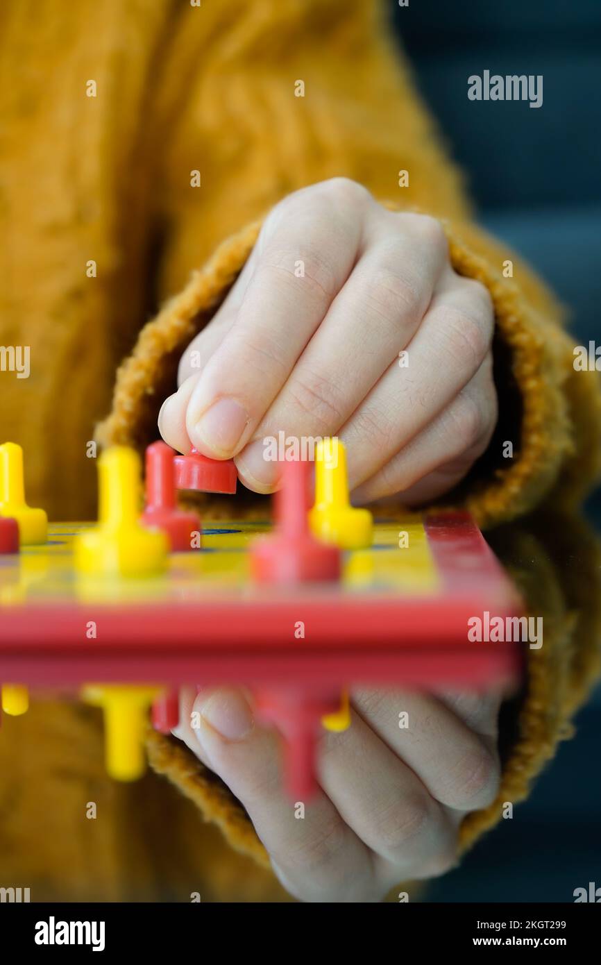 Hand of a female player moving a tile in a board game Stock Photo - Alamy
