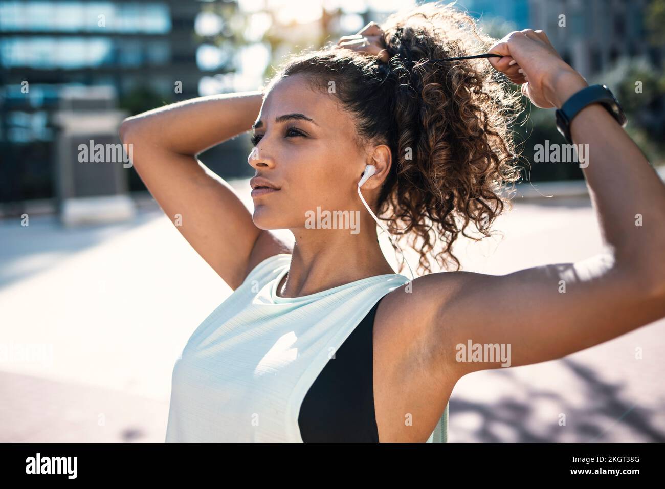 Woman tying hair up hi-res stock photography and images - Alamy