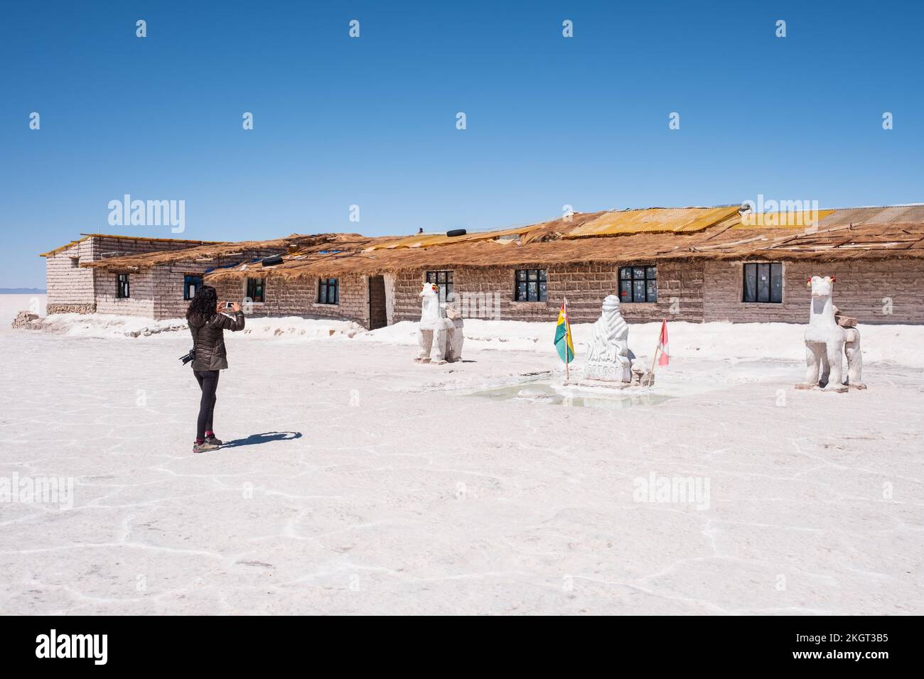 Female tourist photographs the Comedor de Sal (Salt Restaurant) on the ...